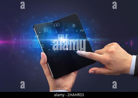Businessman holding a foldable smartphone with FILE SECURITY ...