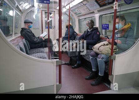 Commuters on a northbound Bakerloo Line Underground train carriage at ...