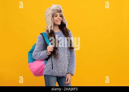 happy teen girl in knitwear sweater and hat having fun with raised ...