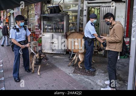 Hong Kong, China. 10th Dec, 2021. A pedestrian walks past an American ...
