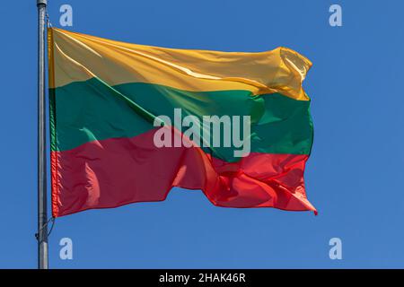 Lithuanian national flag waving on blue sky background. Republic of ...