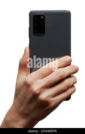 Hand holding a smartphone with blank grey screen. Isolated on white ...