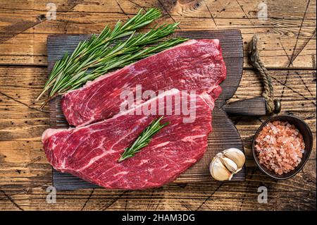 Raw rump cap steak or Picanha steak on wooden board with butcher knife ...
