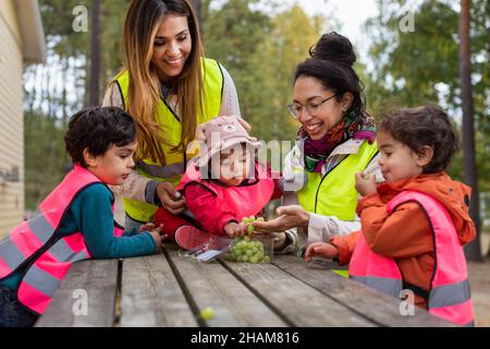 Preschool student eating grapes outdoors Stock Photo - Alamy