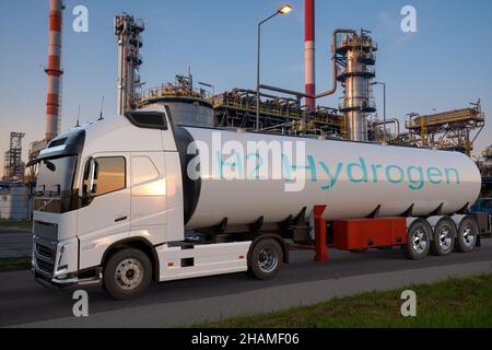 Truck with hydrogen fuel tank trailer on a background of H2 filling ...
