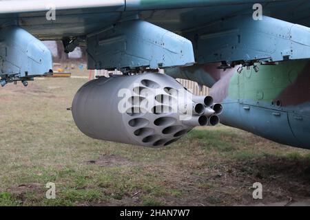 Rocket launcher under the wing of fighter aircraft. Focus on rocket pod ...