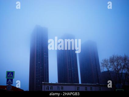 Multiple skyscrapers in fog scary architecture Stock Photo - Alamy
