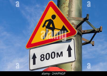 Men at Work roadside works warning sign with excavations in the ...