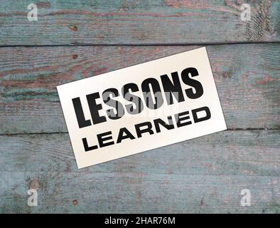 blank card with text Lessons learned on wooden background. Business ...