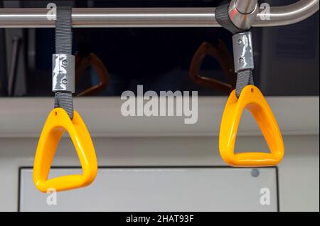 Handrail in the bus. Yellow hand handle. Passenger holder. The interior ...