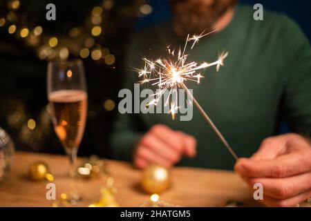 man holding sparkles and champagne glass New Year party Stock Photo - Alamy