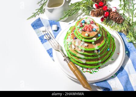 Stack of green colored breakfast pancakes, like Christmas tree with ...
