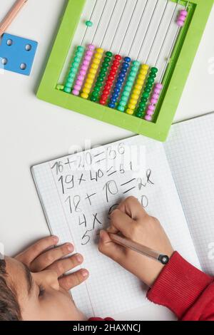 Doing mental math or mental arithmetic. Hand of person using abacus for ...