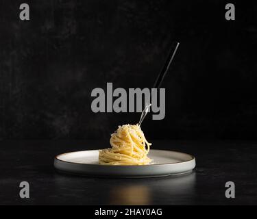 Spaghetti fork on dark black background / Traditional delicious food ...