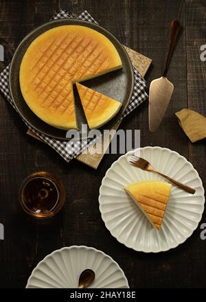 From above plates with tasty cotton cheesecake placed near glass of ...