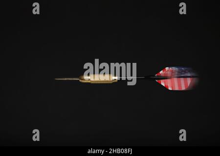 Concept flying dart straight at target for playing darts with color of ...