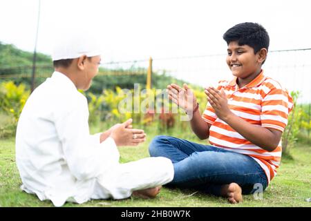Happy Hindu muslim multiethnic kids by playing by clapping hands ...