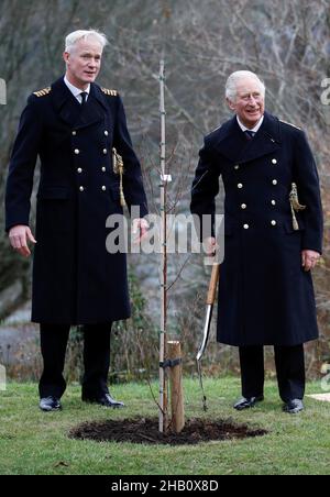 The Prince of Wales (right) plants a tree next to Captain Roger Readwin ...