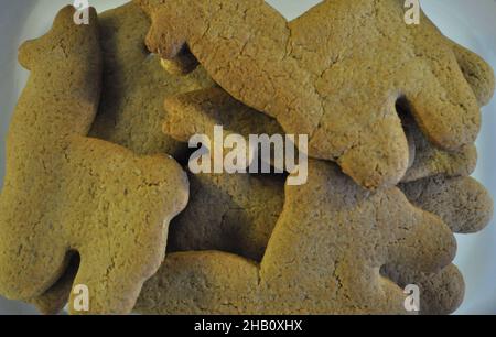 Homemade gingerbread llama shaped biscuits on a baking tray ready to be ...
