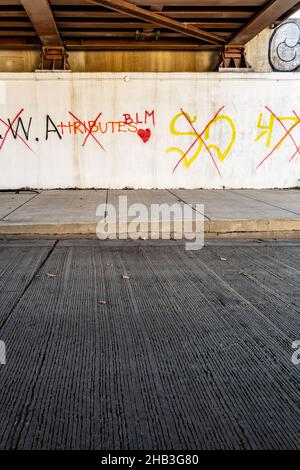 White wall with various graffiti where the original graffiti of NWA and ...