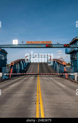 The double-leaf bascule drawbridge is midway between being open or ...