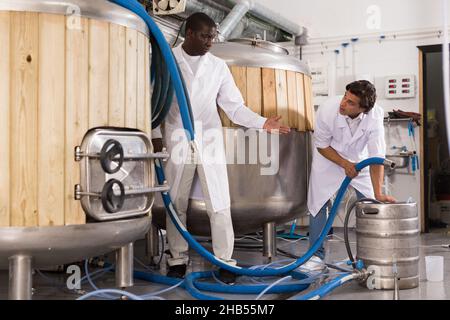 Brewers working on his workplace in the brew-house Stock Photo - Alamy