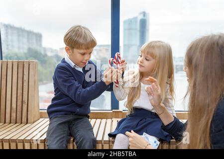 mom gives children candy canes Stock Photo - Alamy