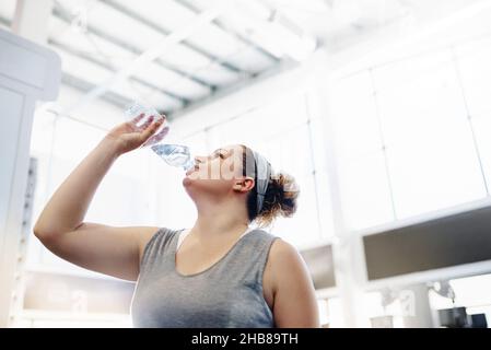 Staying hydrated after working up a sweat. a sporty young woman ...
