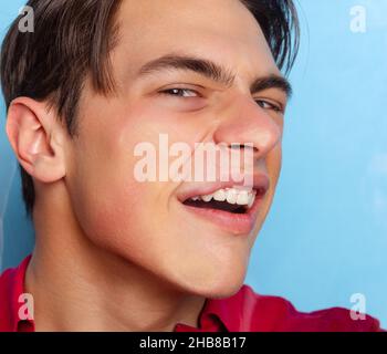 Young handsome man, student leaned against transparent glass isolated ...