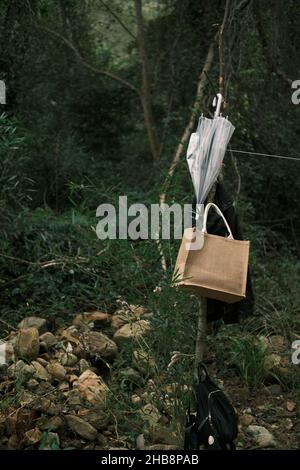Cardboard paper bag hang on one finger isolated on white studio ...