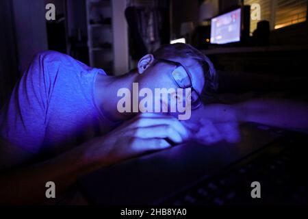 Young guy smoke cigarette, blows smoke, dressed in a retro style, in a ...