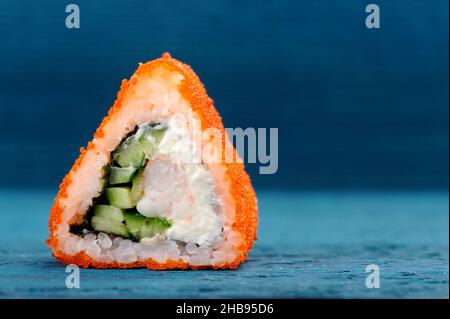 Triangular vegetarian rolls with cucumber, cream cheese and orange roe ...