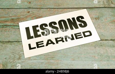 blank card with text Lessons learned on wooden background. Business ...