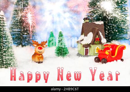 Toy reindeer, wooden Christmas sleigh, silver tinsel and snowflakes on ...