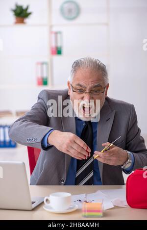 Old businessman employee cutting his hand at workplace Stock Photo - Alamy