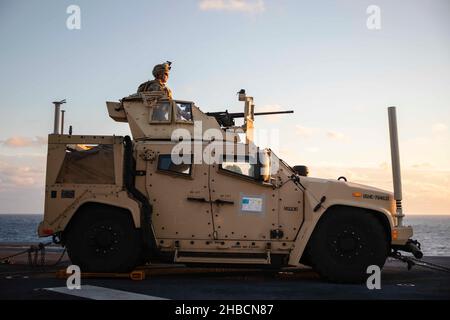 A Navy gunner mans his 50 caliber machine gun on utility boat as it ...