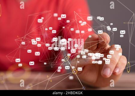 A hand touching 3D rendered email icons, online communication concept ...