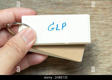 Man hold the flash card with handwriting word PDCA (Abbreviation of ...