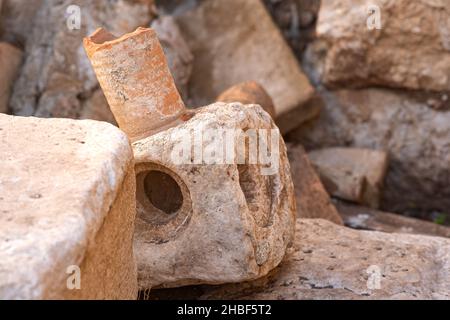 elements of ancient roman water pipes among the ruins of an antique ...