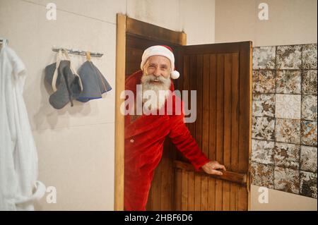 Happy relaxed Santa Claus coming out steam-room Stock Photo - Alamy