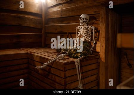 Skeleton steaming with oak broom in sauna Stock Photo - Alamy