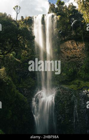 A mesmerizing waterfall and river on a sunny day in summer Stock Photo ...