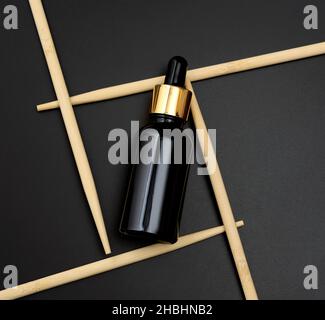 Brown glass bottle with a pipette on a blue background Stock Photo - Alamy