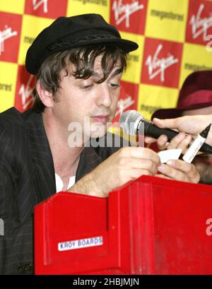 Danny Goffey of Supergrass sign copies of their latest album "Road To ...