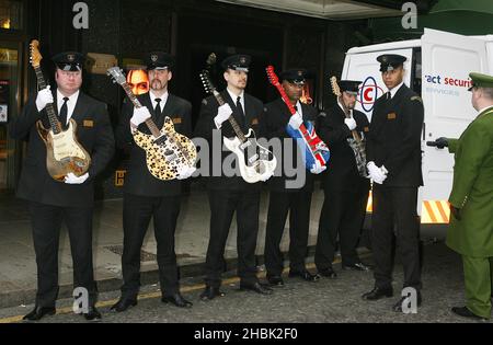 Security guards hold the worlds most valuable electric guitars, (left ...