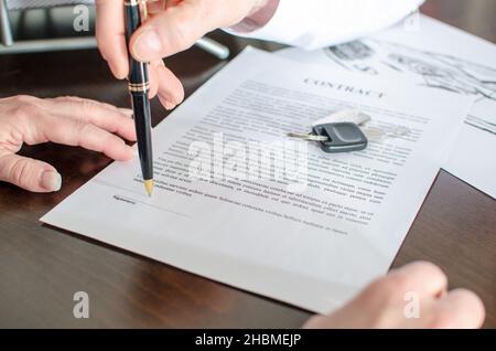 Dealer showing the signature place of a contract with his finger ...