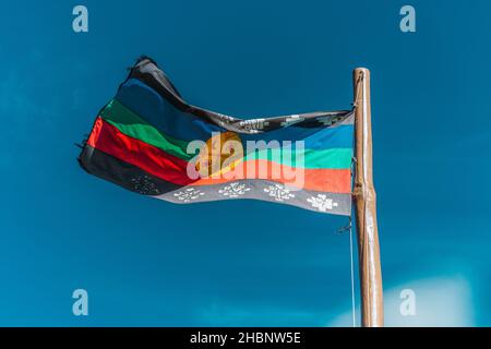 Flag of the original Mapuche people in blue sky Stock Photo - Alamy