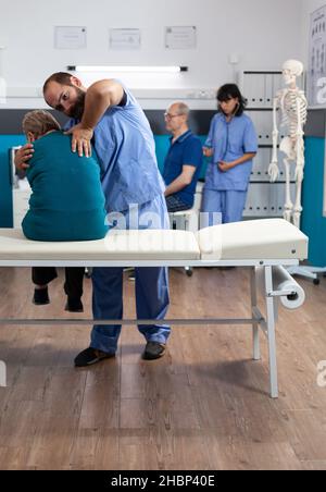 Osteopathy specialist relieving pressure from back bones of senior ...