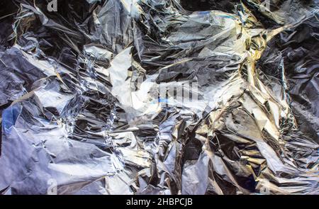 A stretched plastic bag reveals stress patterns under polarised light ...