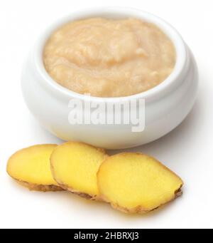 Ginger with paste over white background Stock Photo - Alamy